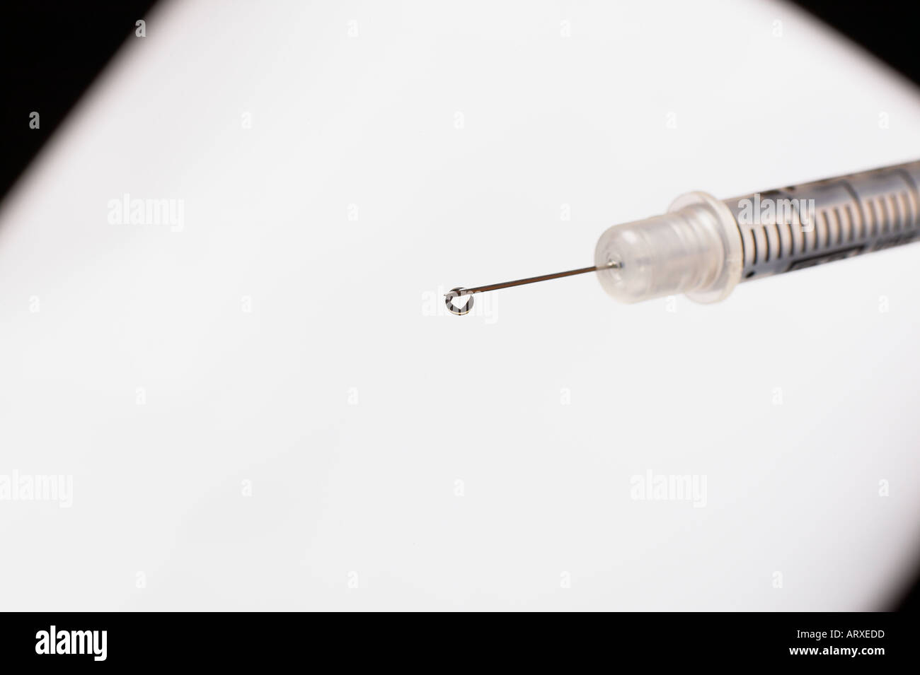 syringe close up with drop of serum at tip Stock Photo - Alamy