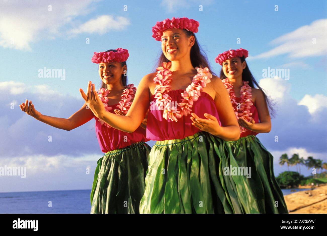 Three hula girls on the beach with pick lei at Alii Beach Park, north ...