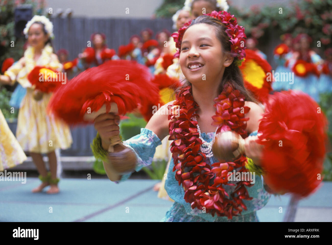 Young hula dancers with feathered uli uli (gourd rattles), Lei Day ...