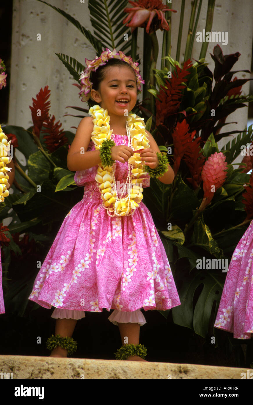 Young hula dancer wearing yellow plumeria lei, Lei Day celebration at ...