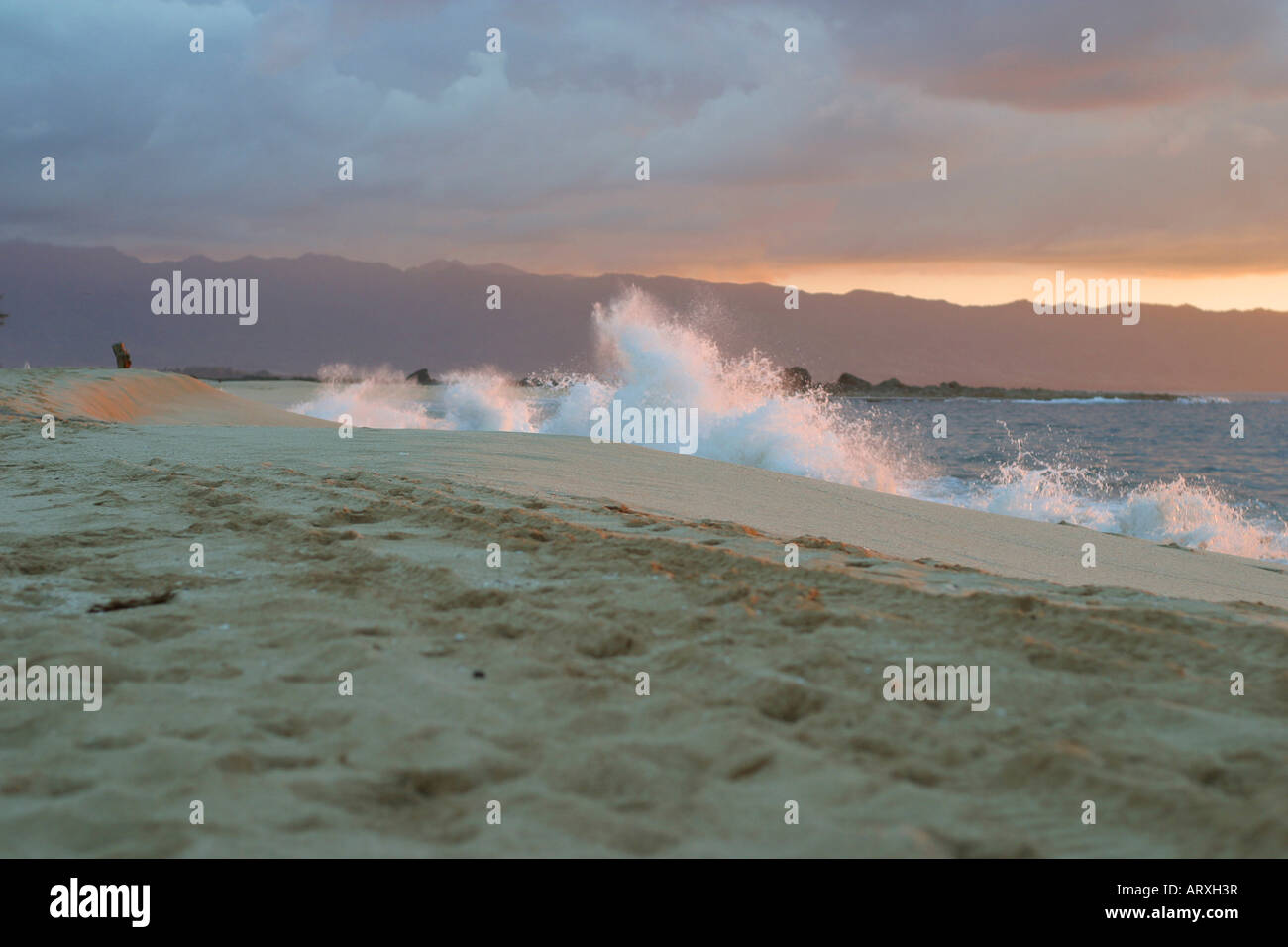 Waves crash on Ke'iki beach on the north shore of Oahu. Clounds over ...