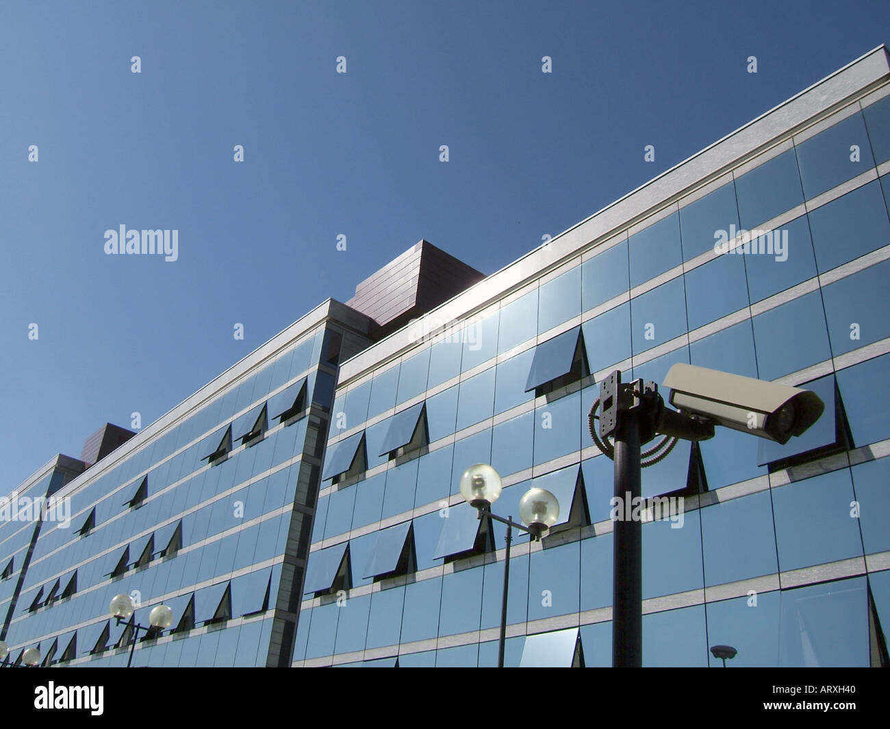 glass office blocks and cctv camera Stock Photo - Alamy