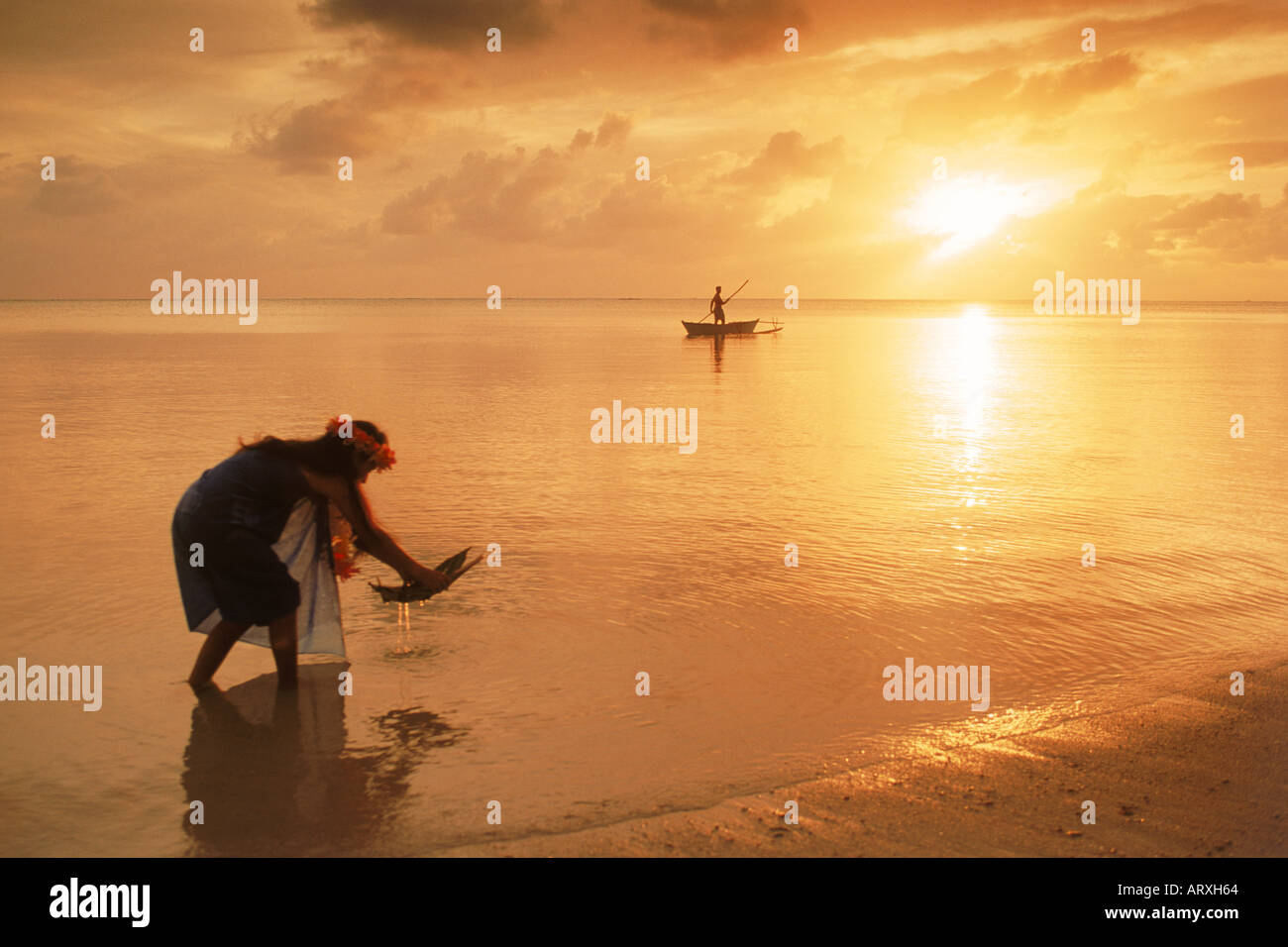 Outrigger canoe in Aitutaki lagoon at sunset with Polynesian girl in ...