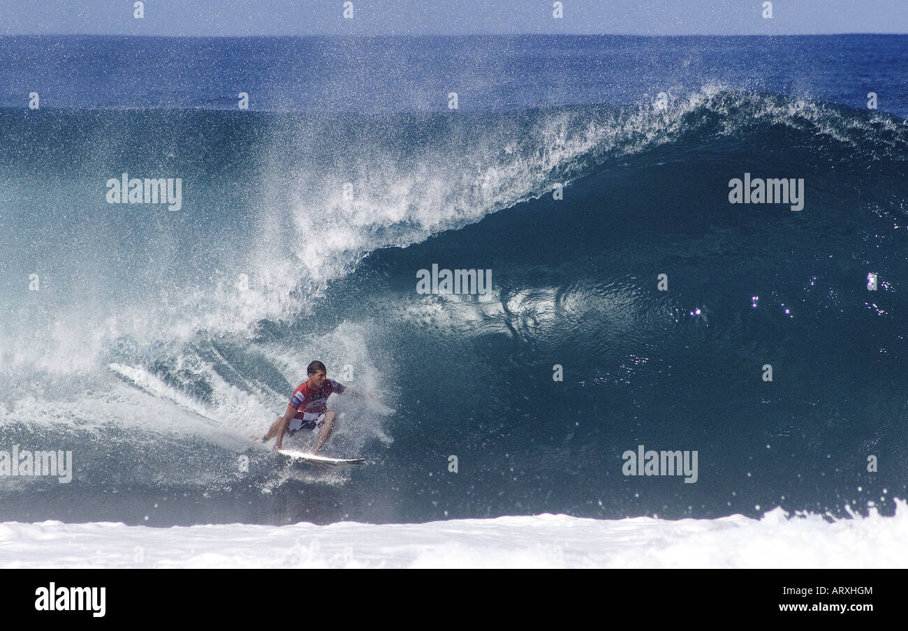 Professional surfer Andy Irons pulling into a barrel at a surf contest ...