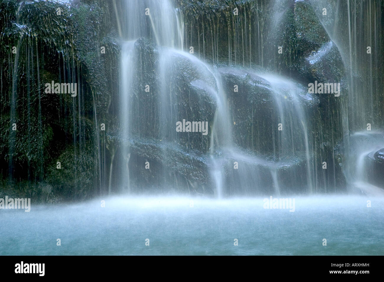Water forms a mist at the base of a waterfall Stock Photo - Alamy