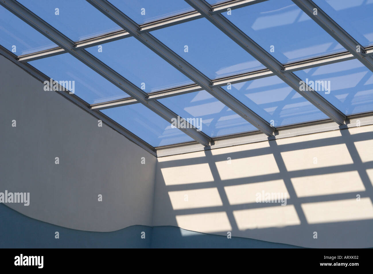 Skylight architecture with shadow patterns over swimming pool in health ...