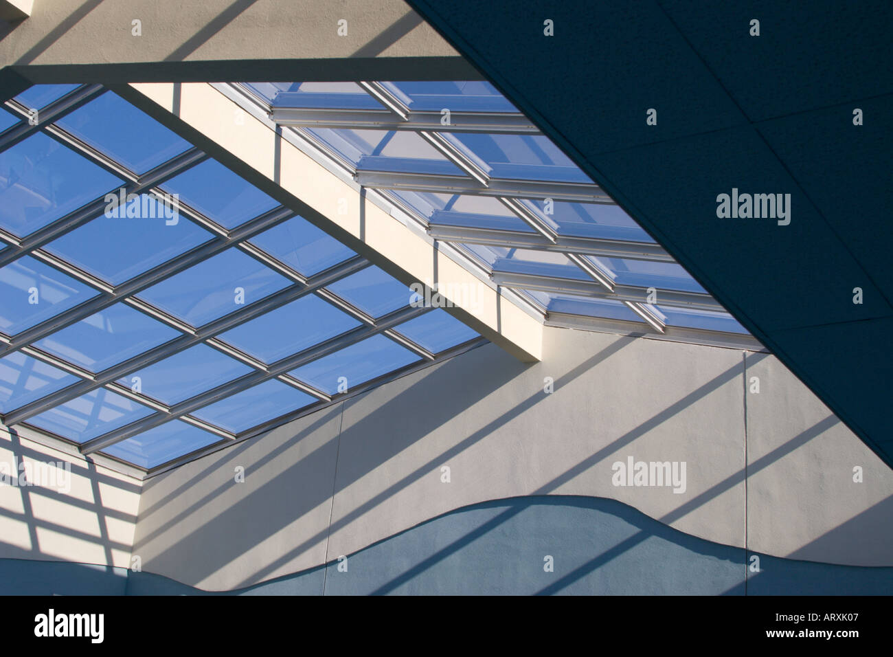 Skylight architecture with shadow patterns over swimming pool in health ...