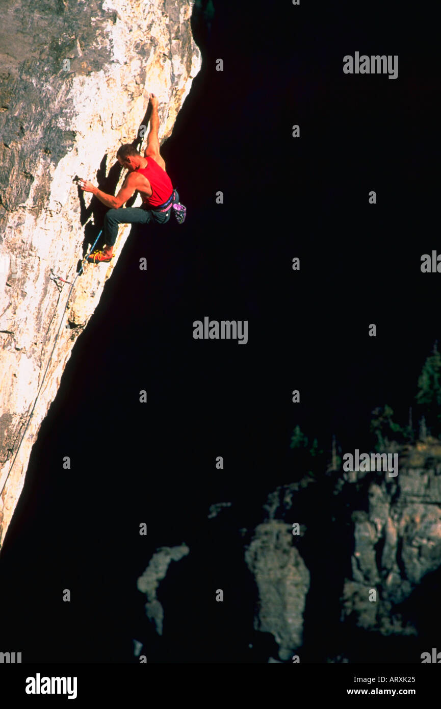 Rock climber hanging from sheer cliff Stock Photo - Alamy