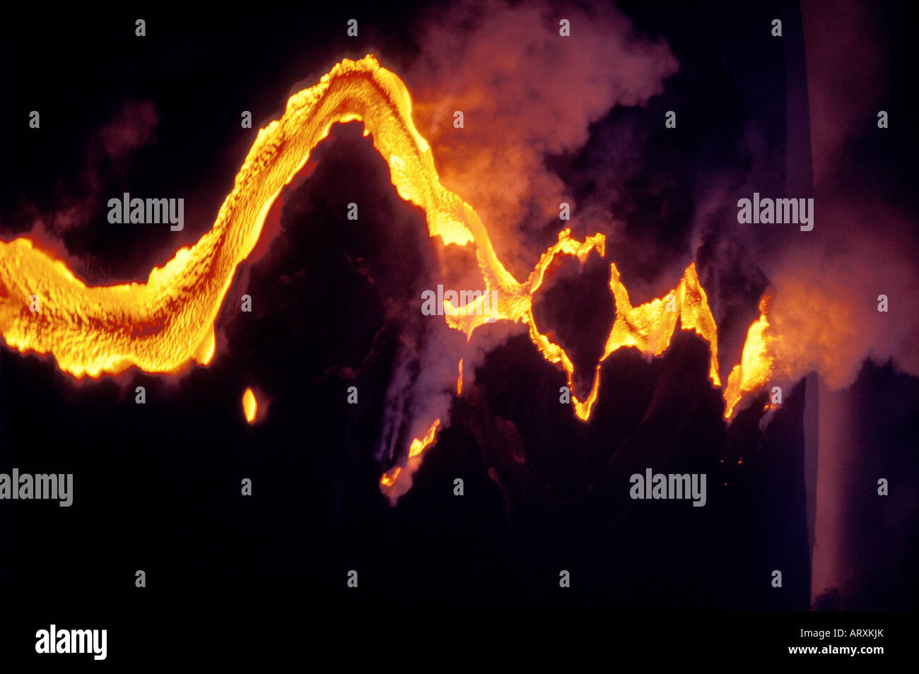 Lava from Kilauea Volcano flowing across landscape after eruption. Big ...