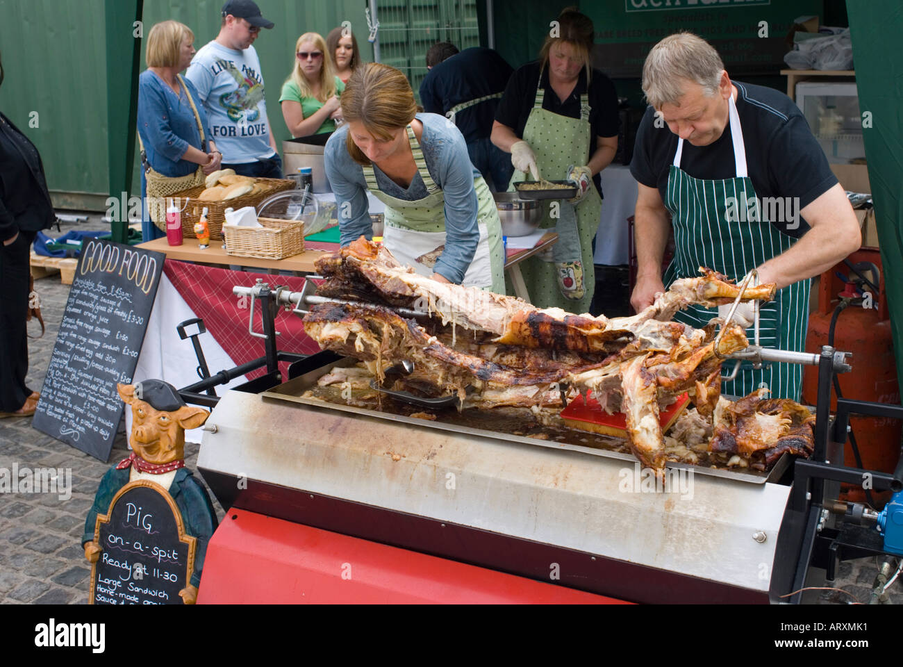 Pig on a spit in Alnwick market Northumberland Stock Photo - Alamy