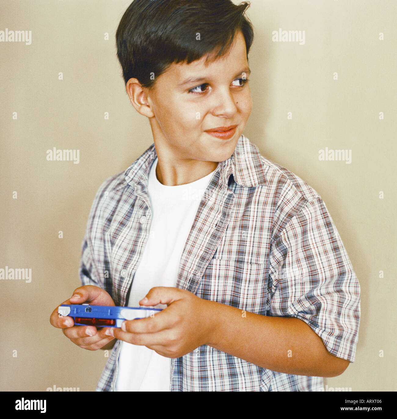 Hispanic Boy Playing Handheld Video Game Stock Photo - Alamy