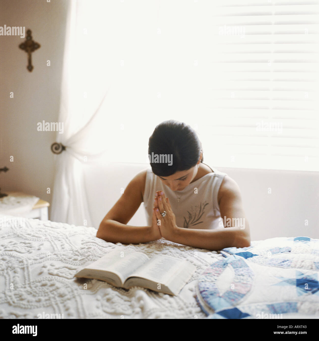 Hispanic Woman Praying with Bible Stock Photo - Alamy