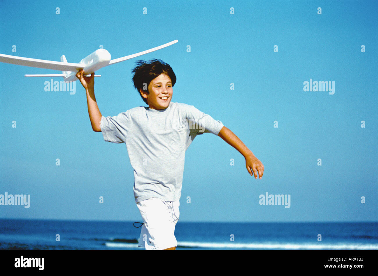 Young Boy with Model Airplane Running at Beach Stock Photo - Alamy