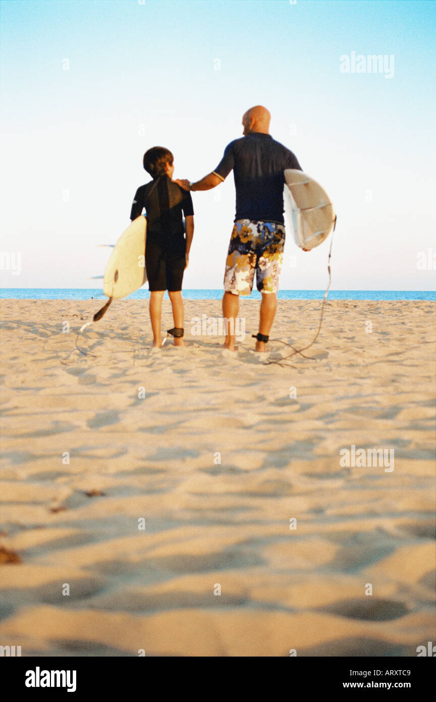Father and Son on Beach with Surfboards Stock Photo - Alamy