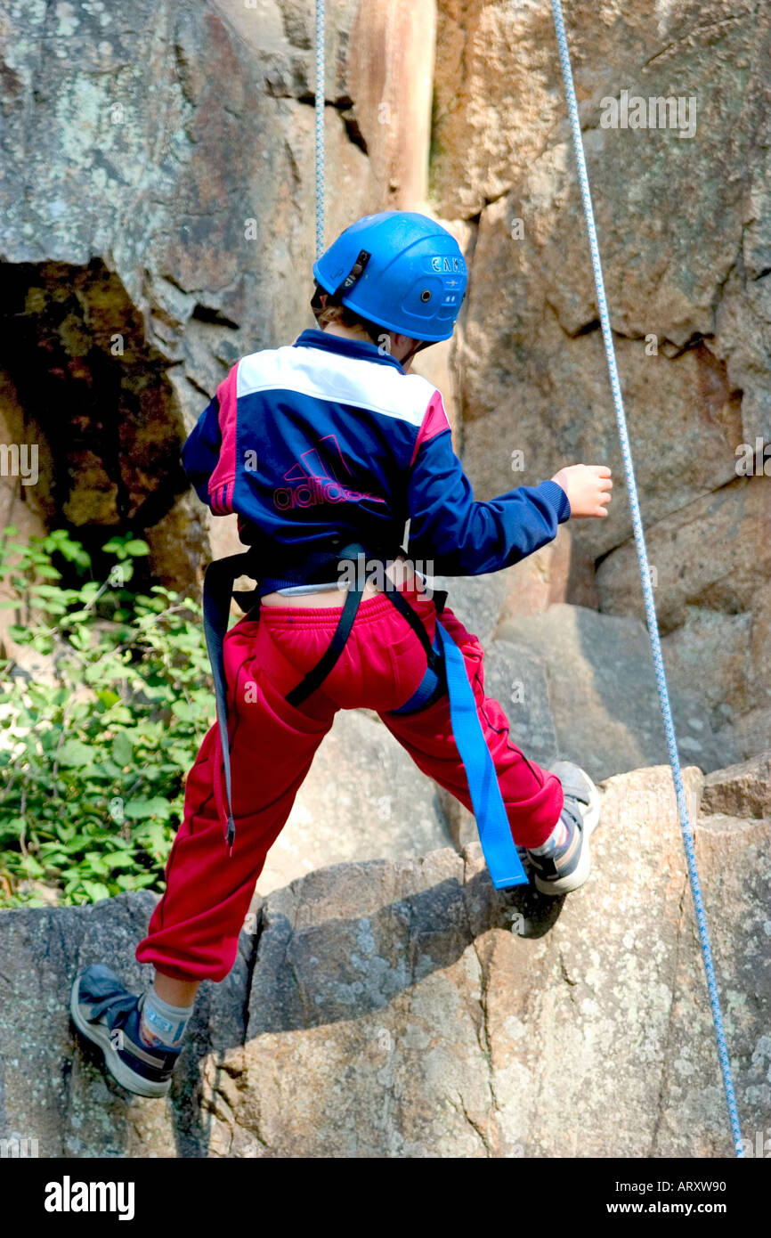 back of male little boy climbing a rock of mountainlegs and feet Stock ...