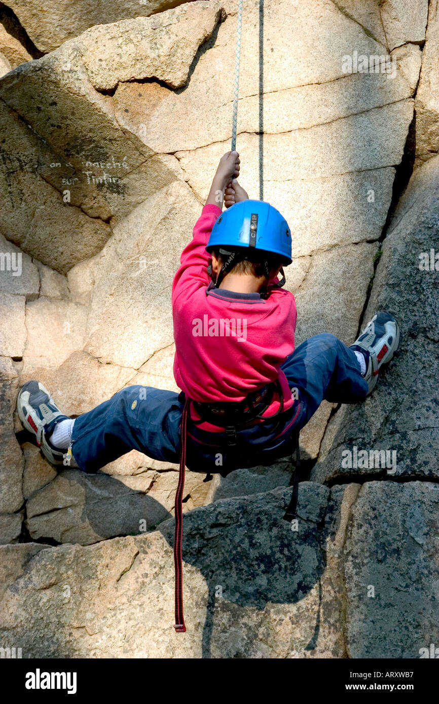 back of male little boy climbing a rock of mountain Stock Photo - Alamy