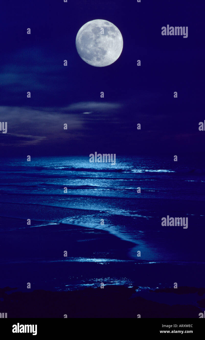 full moon and moonlight reflecting on surf bech rocks Heceta Head ...