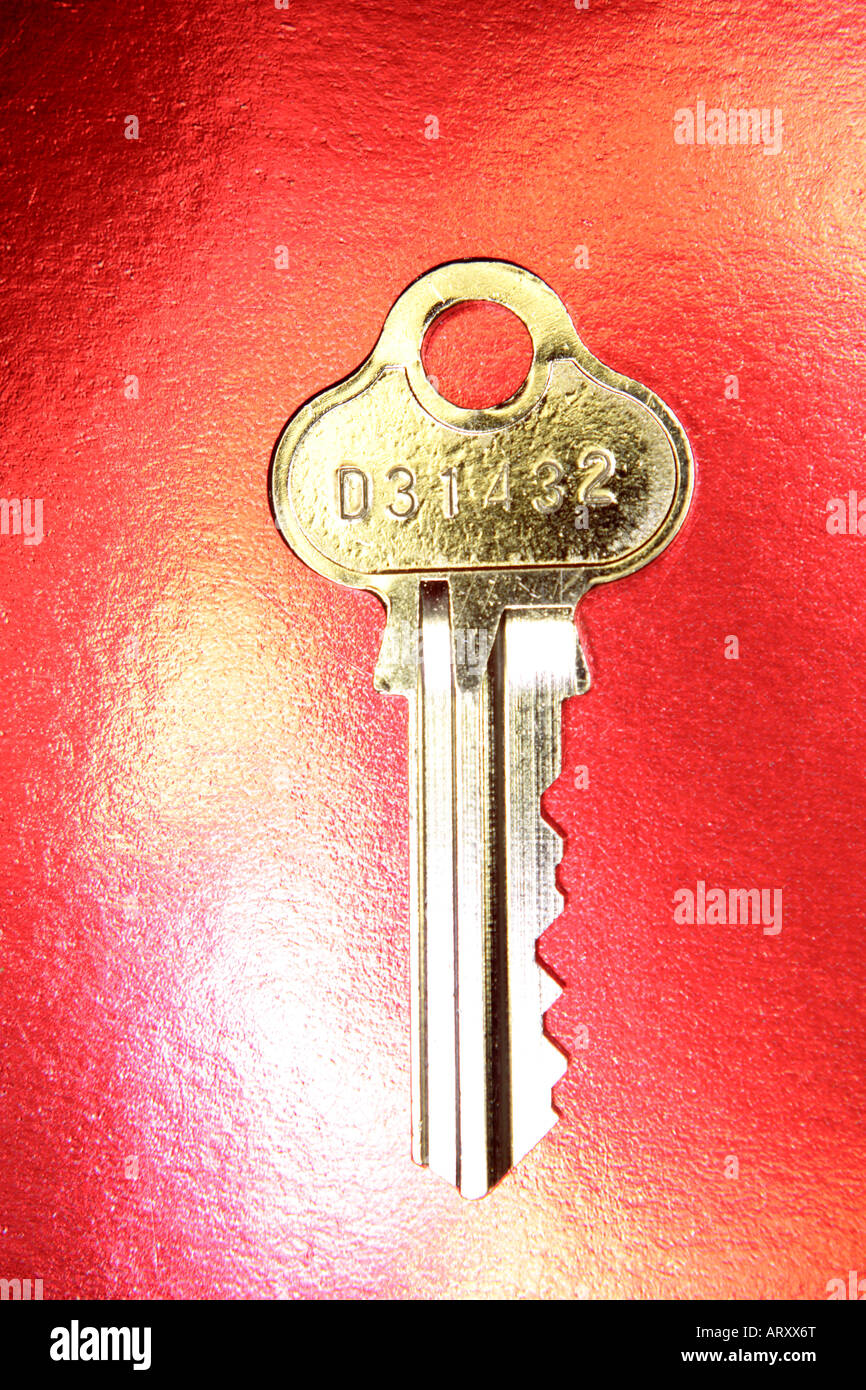 Key on red background Stock Photo - Alamy