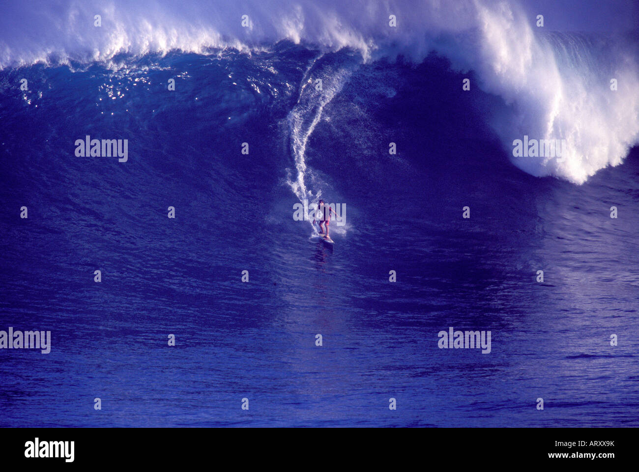 A surfer tow surfing at Jaws on Maui Stock Photo - Alamy
