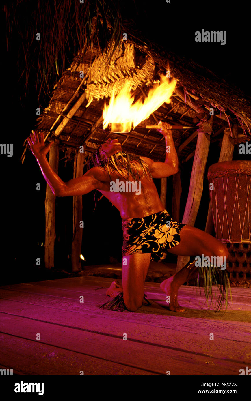 Spectacular Polynesian fire dancer entertains tourists at a luau on the ...