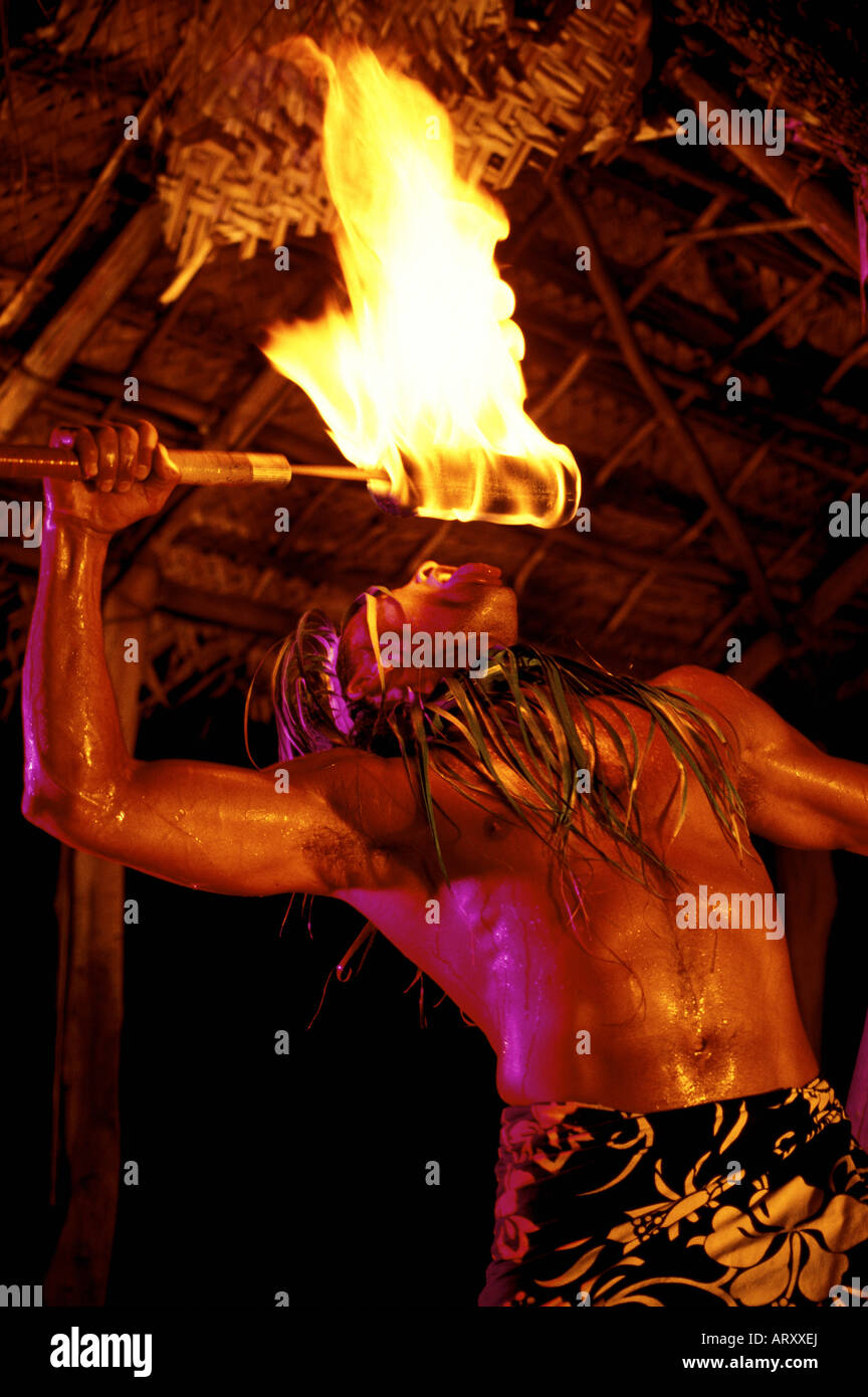 Spectacular Polynesian fire dancer entertains tourists at a luau on the ...