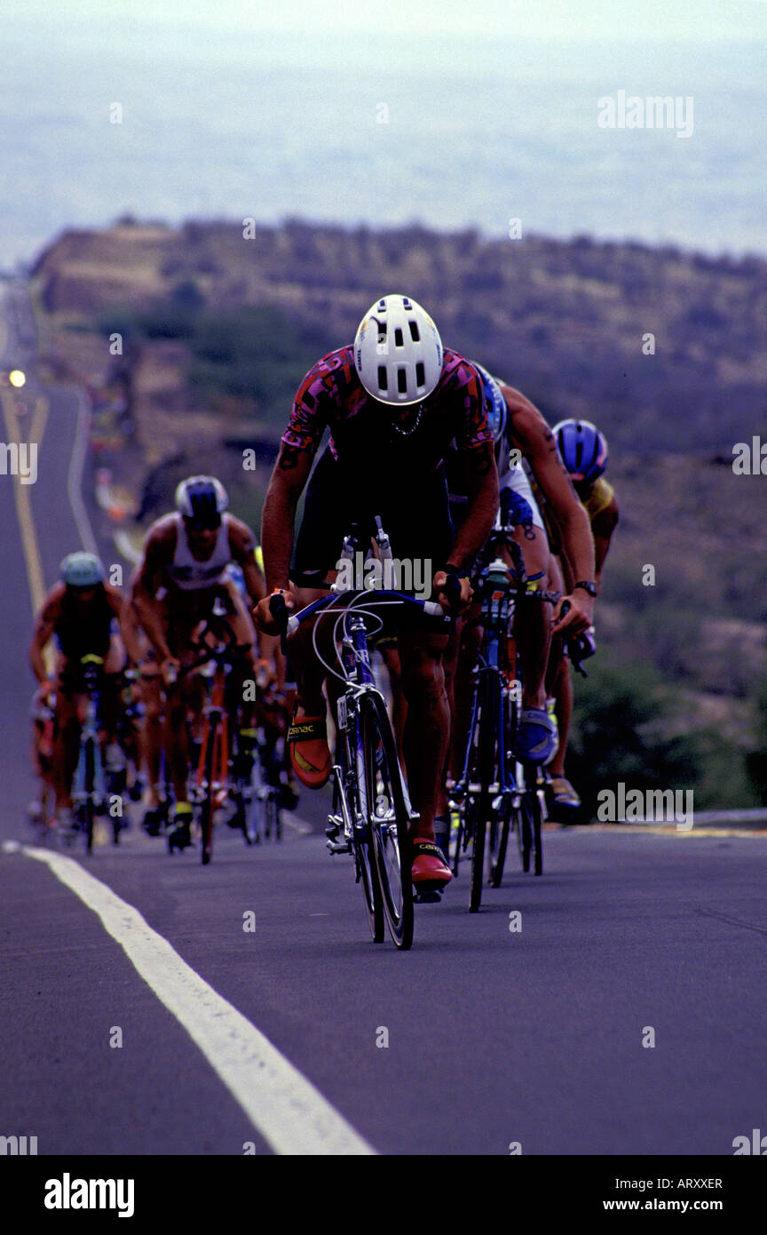Group of muscular cyclists climb hill during 112 mile bicycle component ...