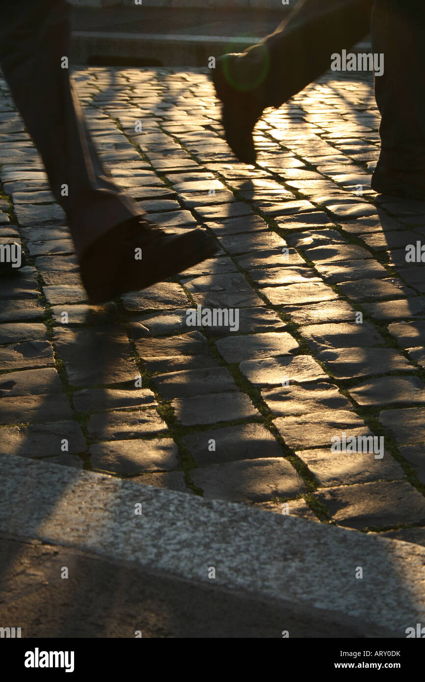 people walking on cobbled street Stock Photo - Alamy