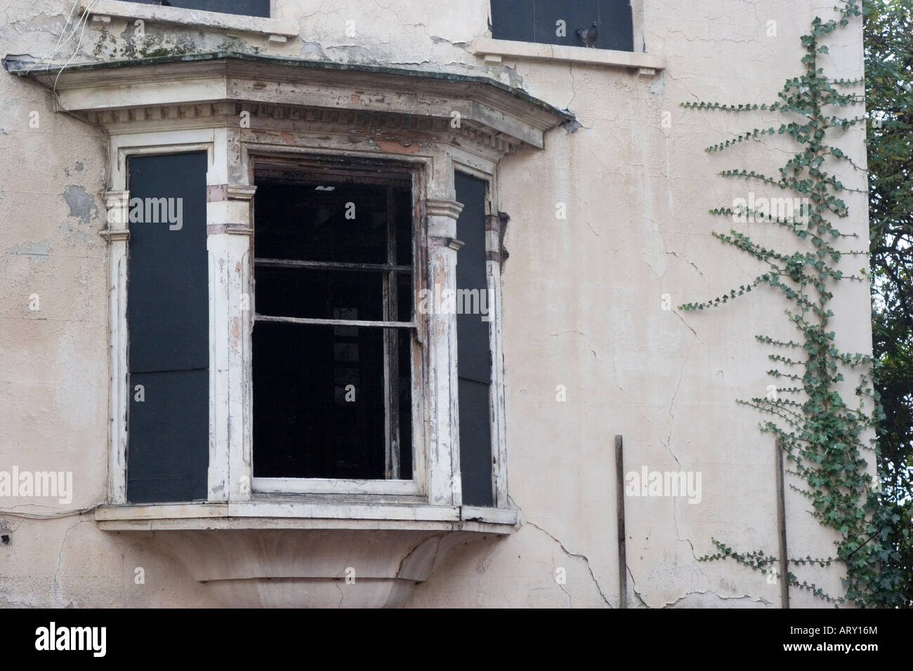 Smashed glass in a bay window of a derelict house Stock Photo - Alamy