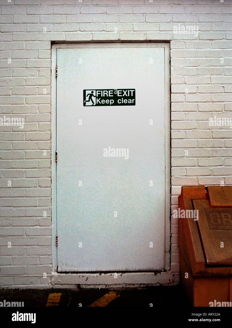 A wooden fire exit leading out of a white painted brick building Stock ...