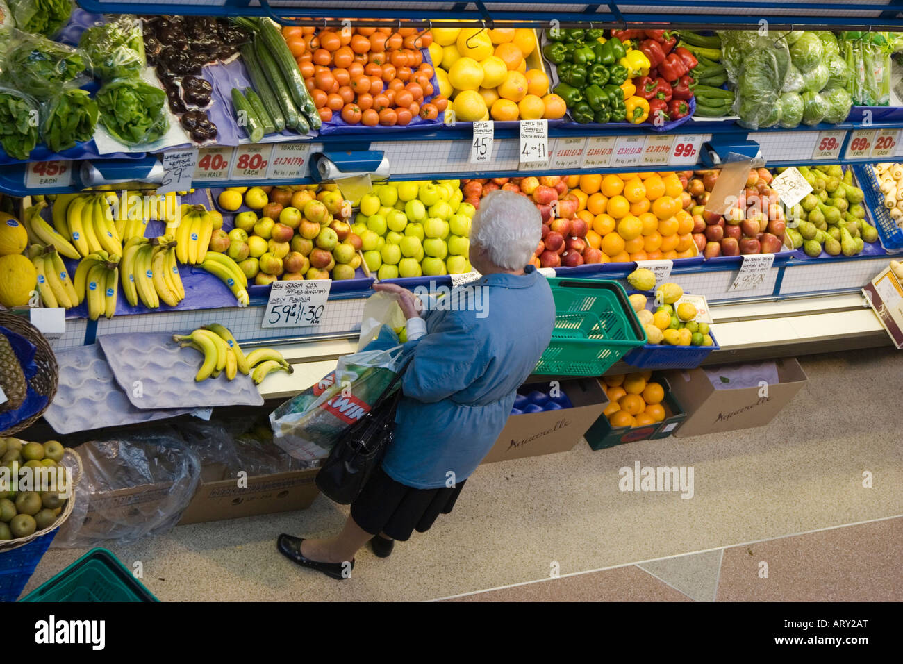 Lady selecting her fruit and vegetables from a market stall Stock Photo ...