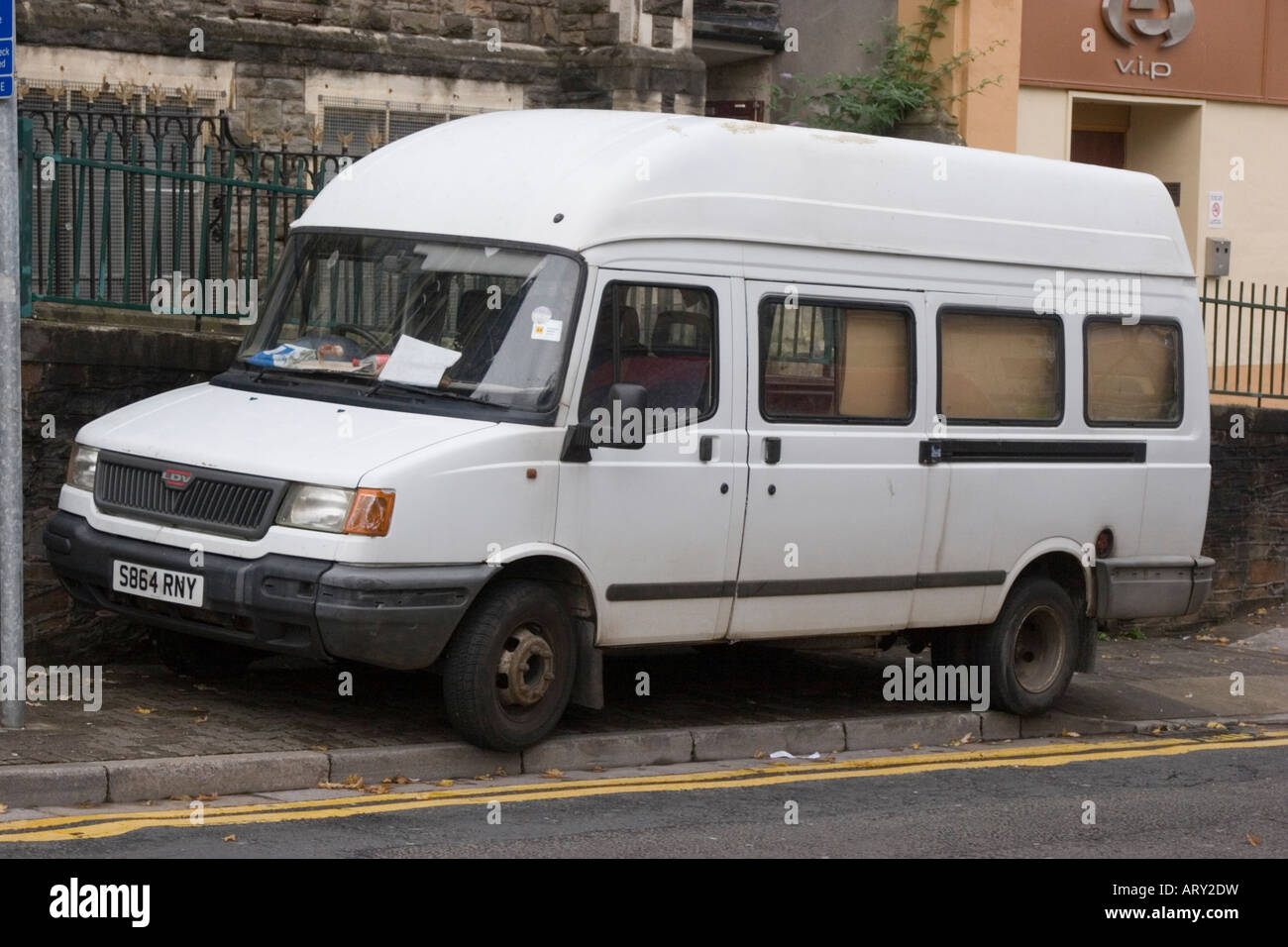 Minibus parked on the pavement and double yellow lines Stock Photo - Alamy