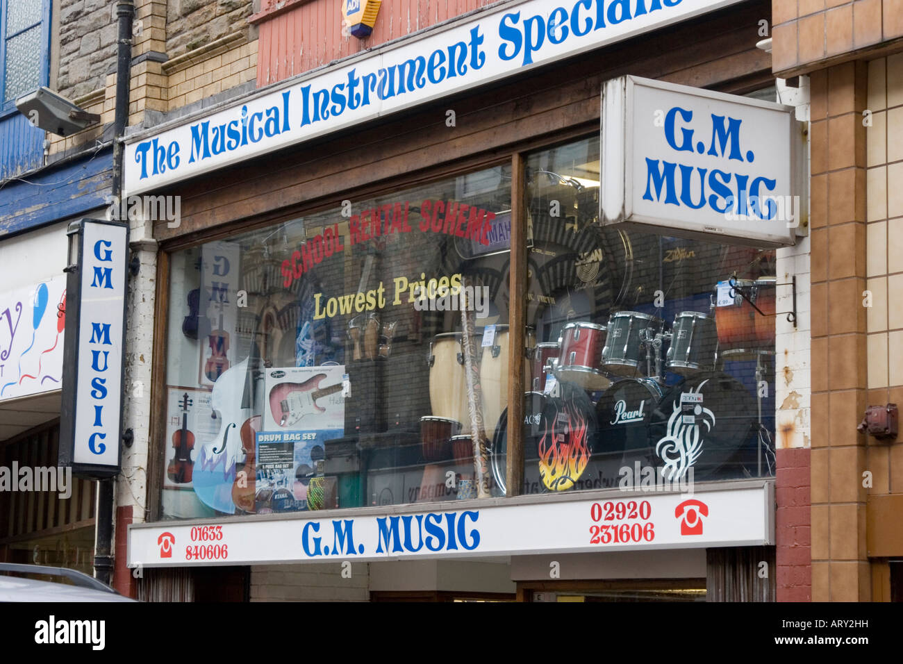 Drum kits displayed in a music shop window Stock Photo - Alamy