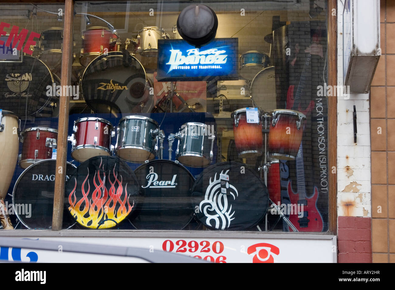 Drum kits displayed in a music shop window Stock Photo - Alamy