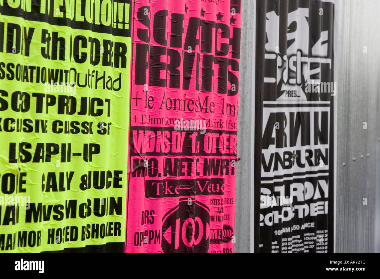 Event posters pasted on corrugated iron sheets Stock Photo - Alamy