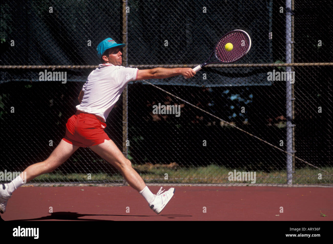 Tennis player hits a backhand Stock Photo - Alamy