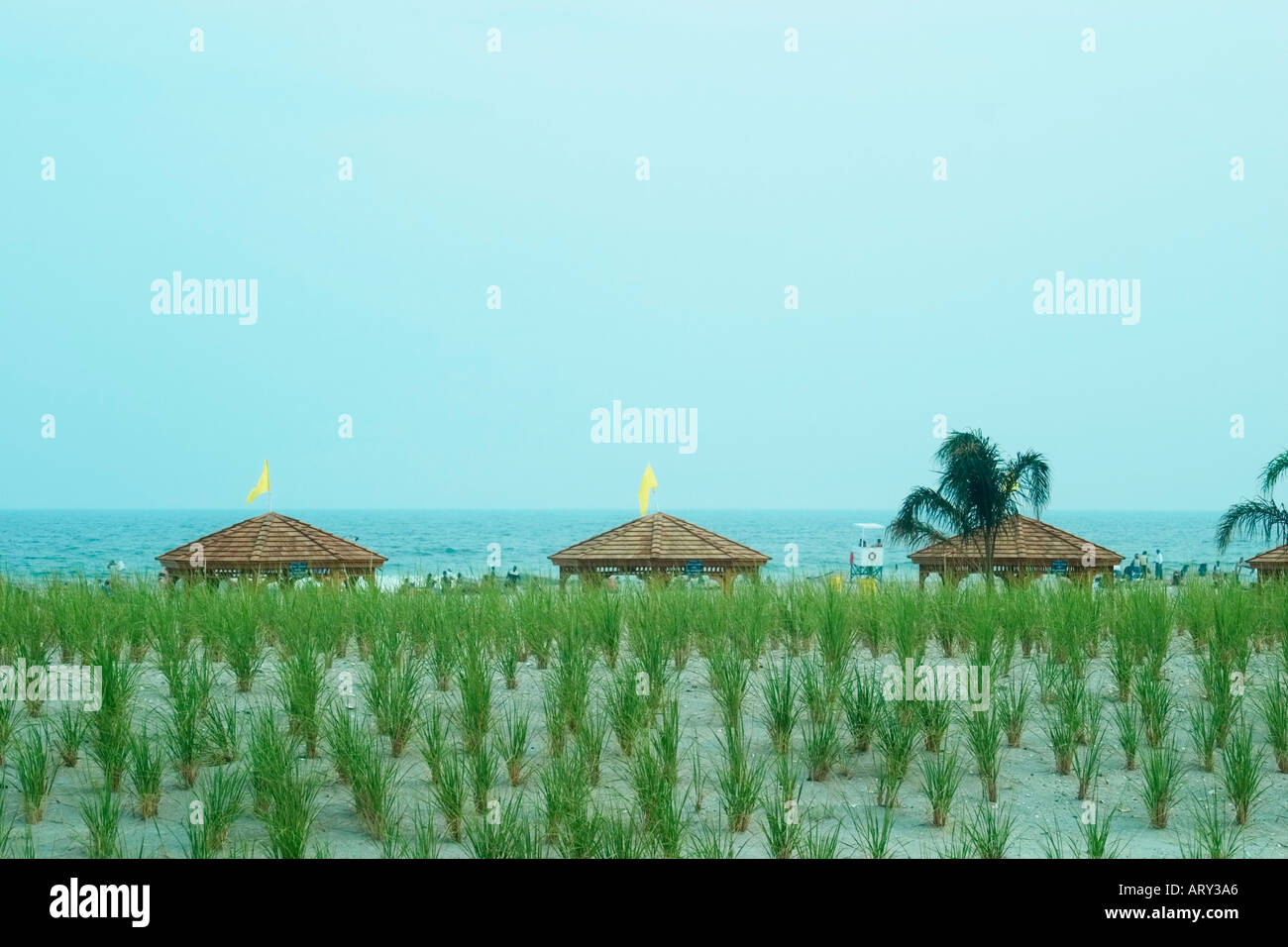Three huts on beach Stock Photo - Alamy