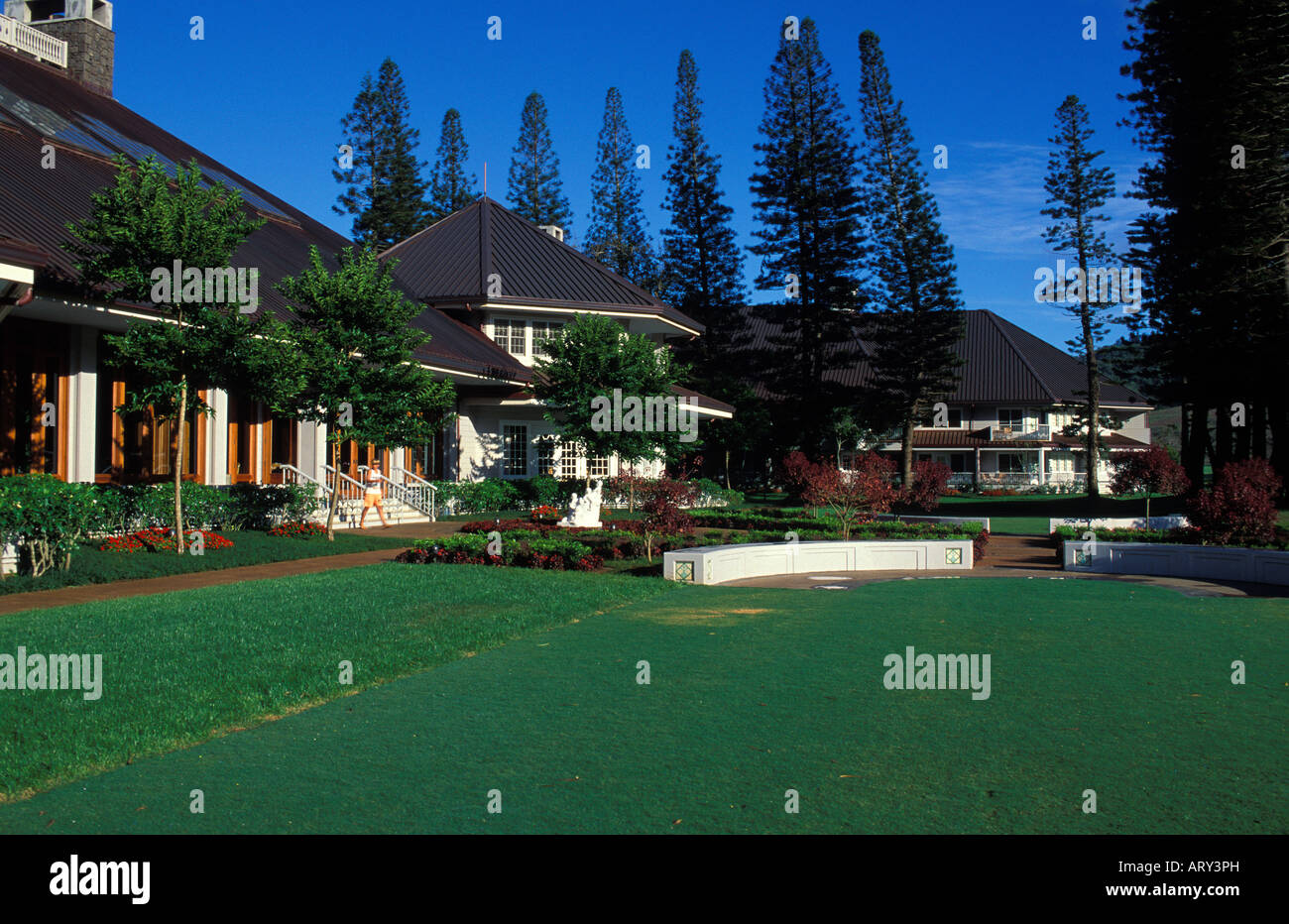 Grounds and buildings of the lodge at Koele, Lanai with a person on ...