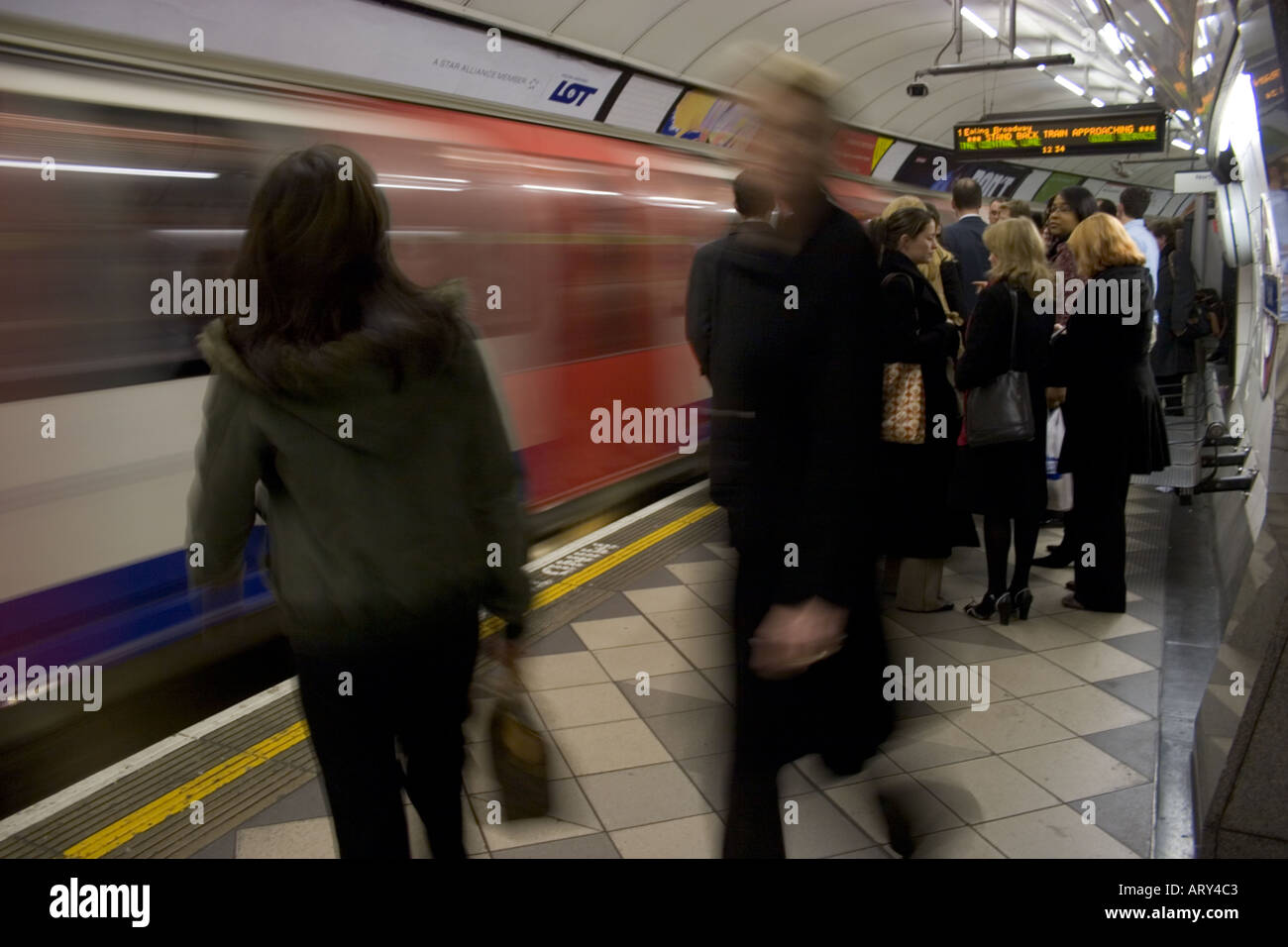 Tube train and tube commuters on the London underground network Stock ...