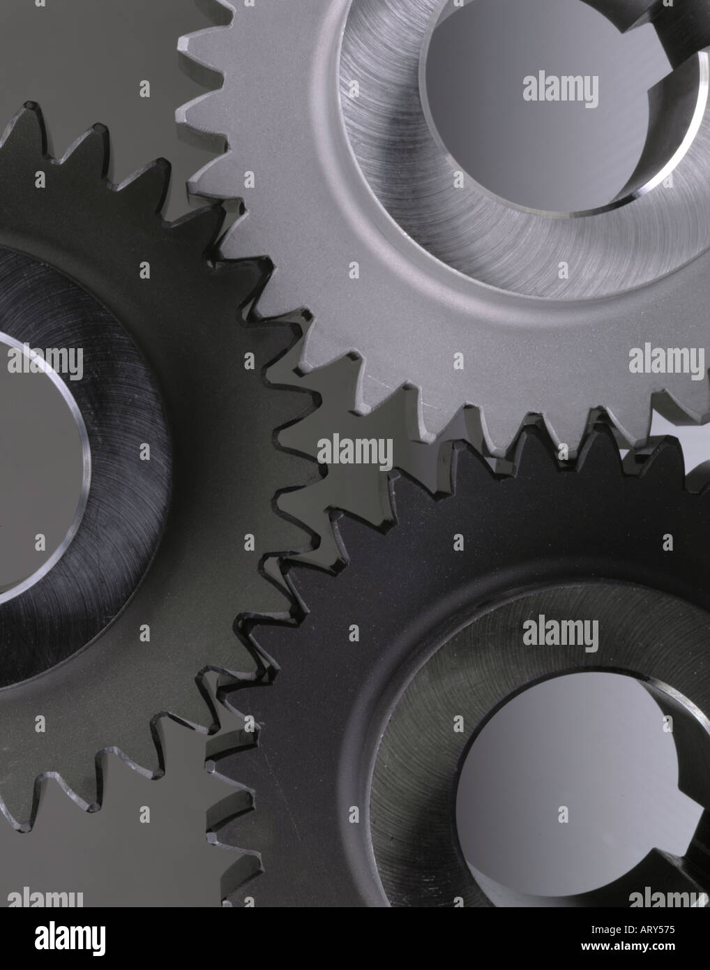 three meshed gears connected Stock Photo - Alamy