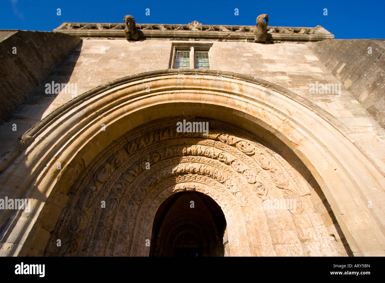 Norman arch and carvings at entrance to Malmesbury Abbey in Malmesbury ...
