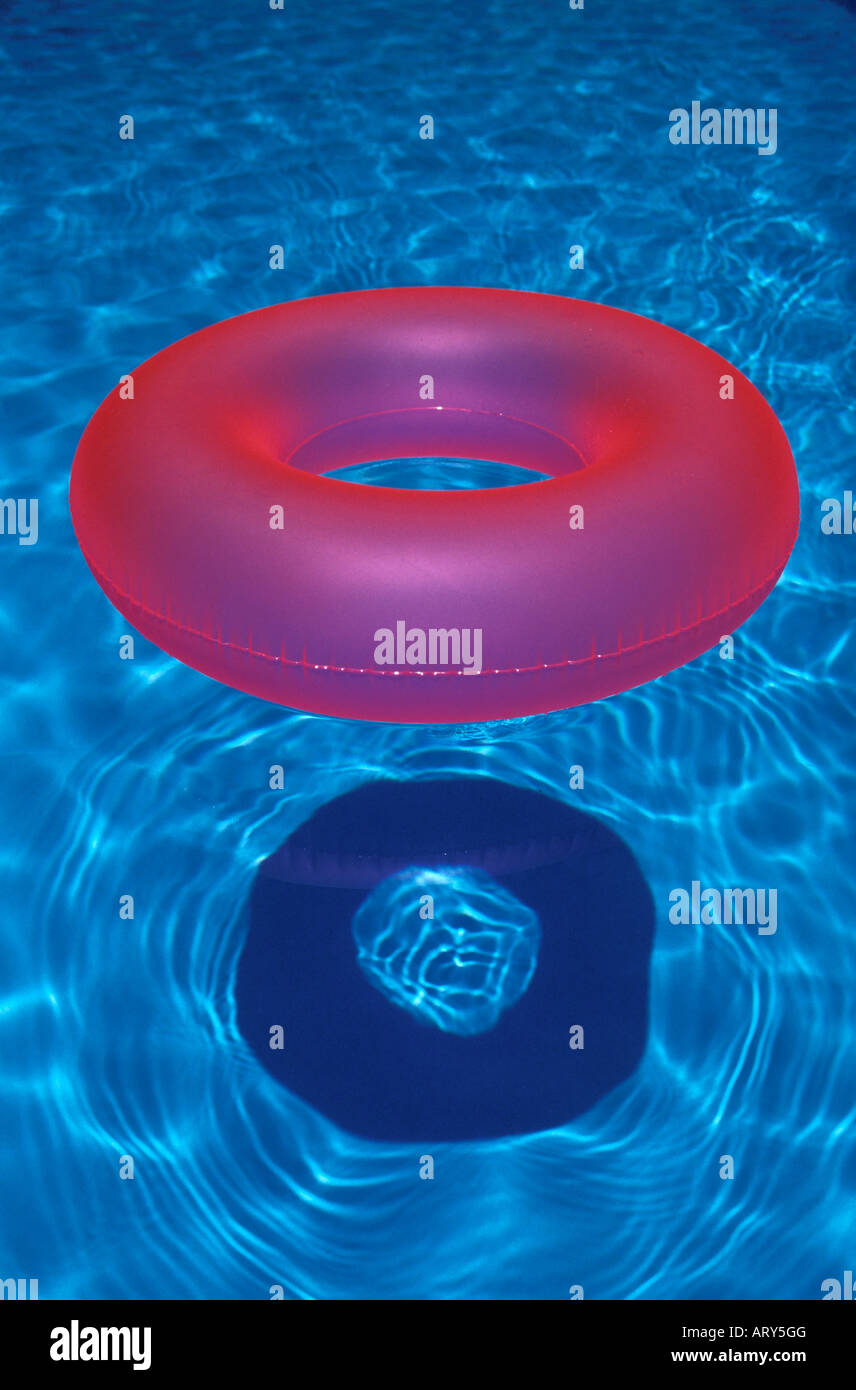 Pink pool ring floats on clear water Stock Photo - Alamy