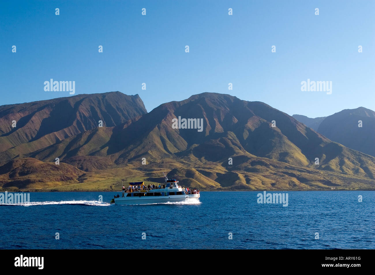 The Lahaina Princess boat cruises in front of the West Maui Mountains ...