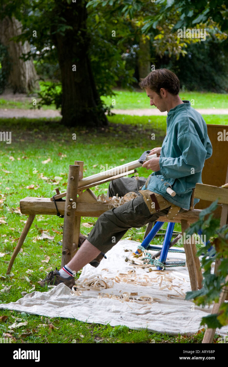Craftsman working on a wood carving at a forest festival Stock Photo ...