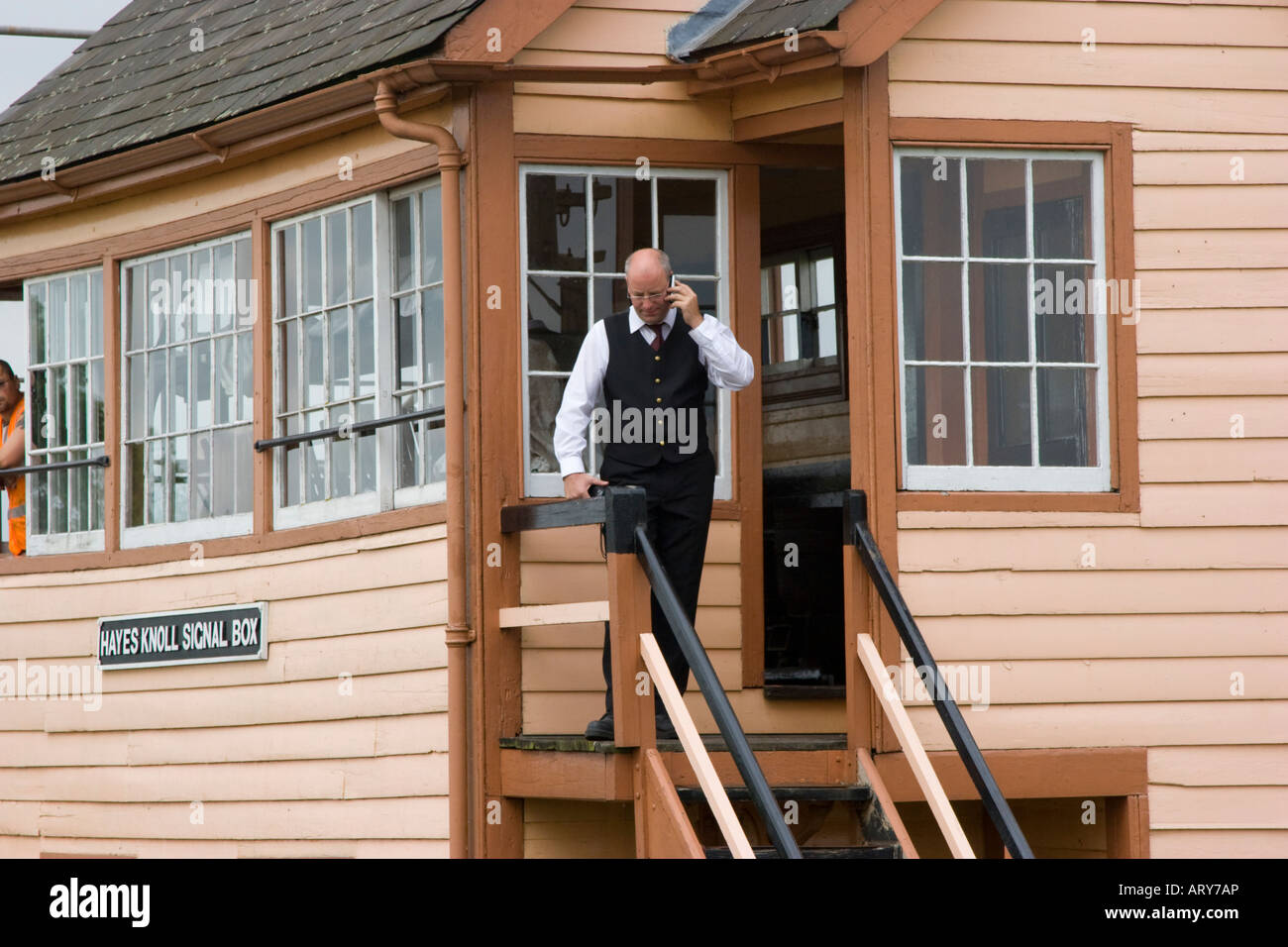 Signalman in railway signal box using mobile phone Stock Photo - Alamy