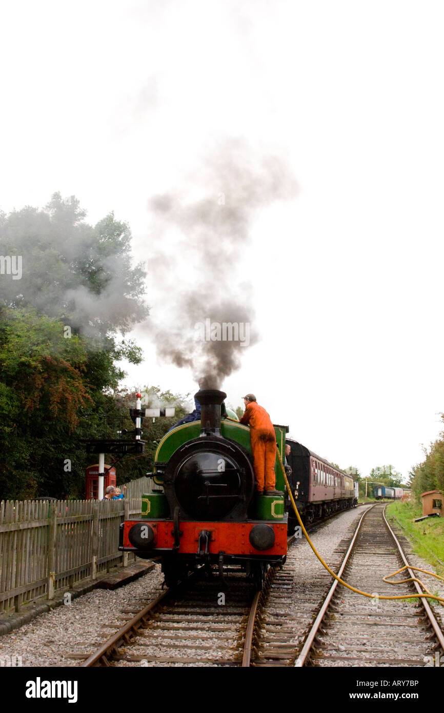 Steam locomotive stopped for water refill Stock Photo - Alamy