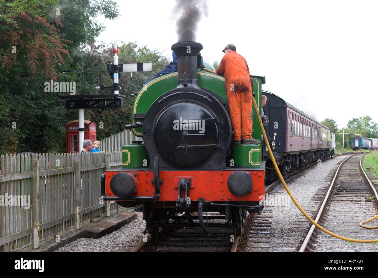 Steam locomotive stopped for water refill Stock Photo - Alamy