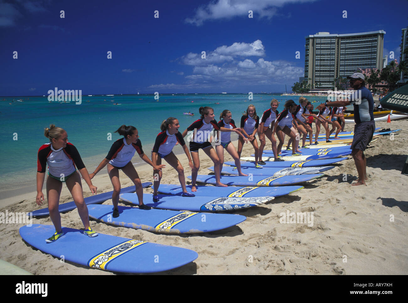 Vacationing high school girls learn the skills of surfing on Waikiki ...