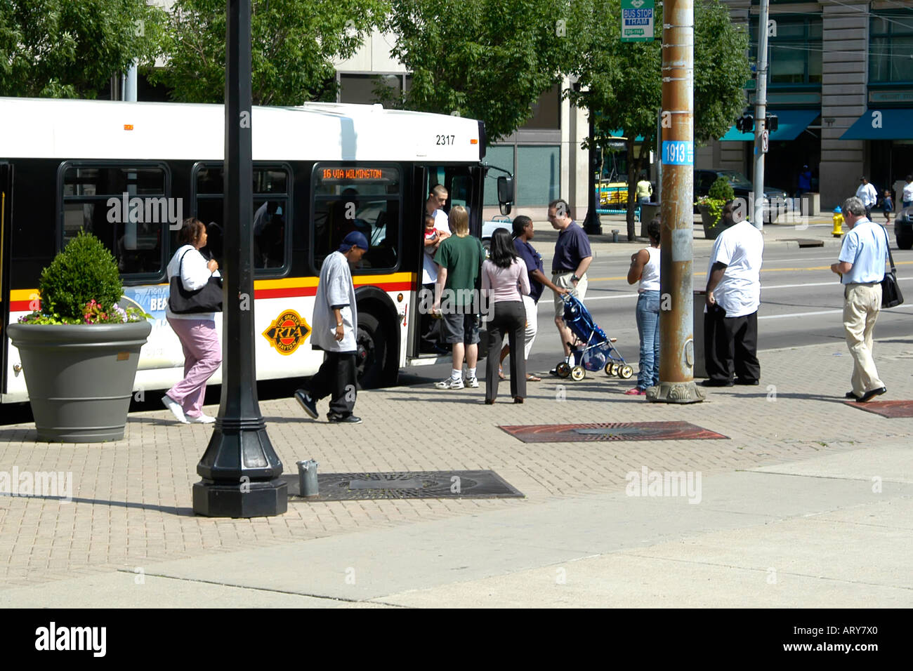 People getting on and off a bus at a stop in Dayton Ohio Stock Photo ...