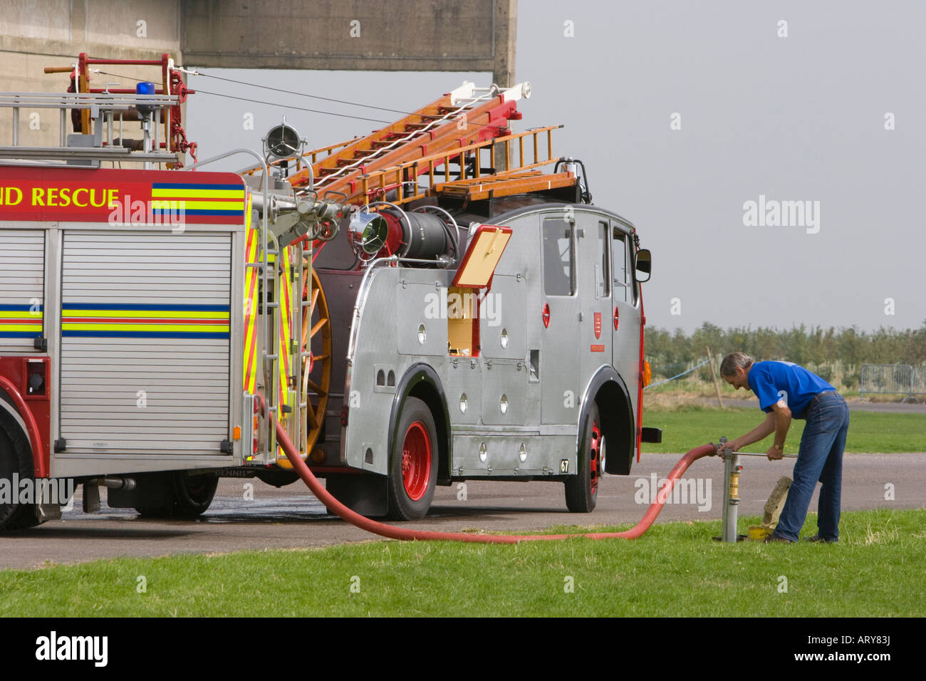 Refilling the water tank of an old vintage fire engine Stock Photo - Alamy