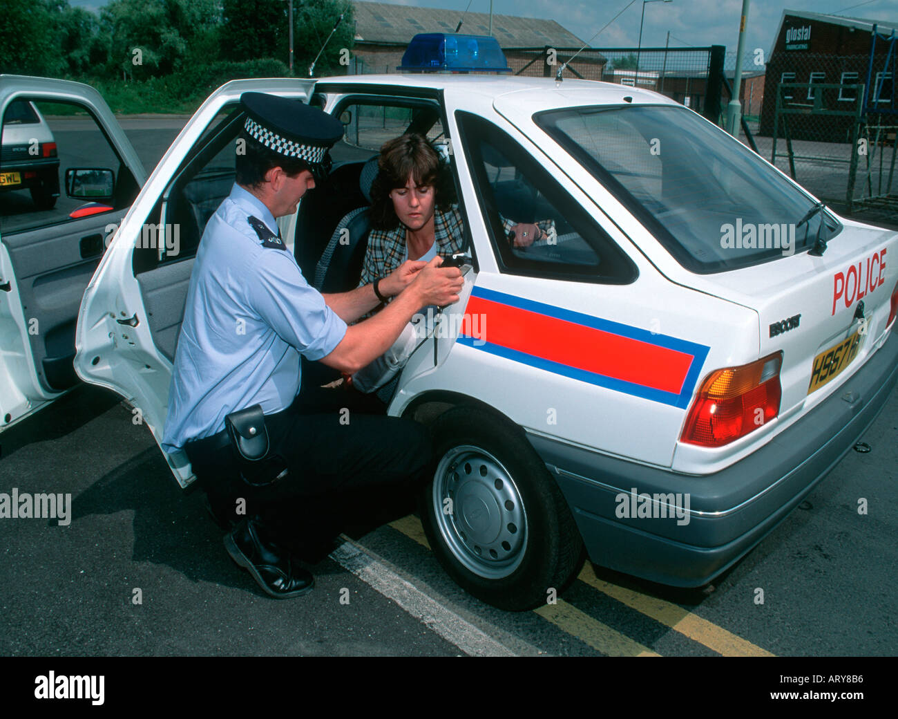 Police constable carries out breathalyser test for blood level alcohol ...